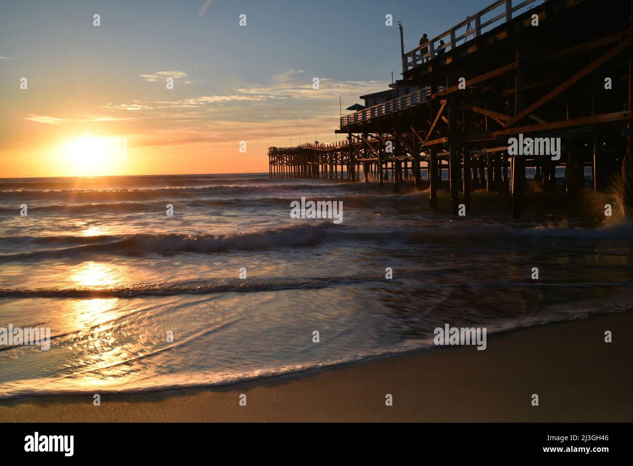 Dramatic sunset with surf waves breaking at Crystal Pier and Crystal ...