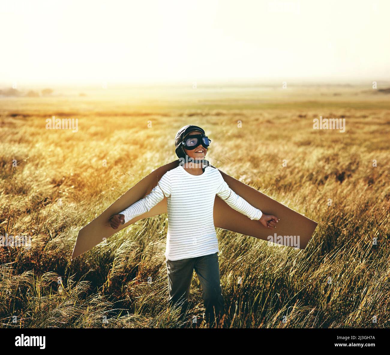 Kids love to let their imagination fly. Shot of a young boy pretending ...