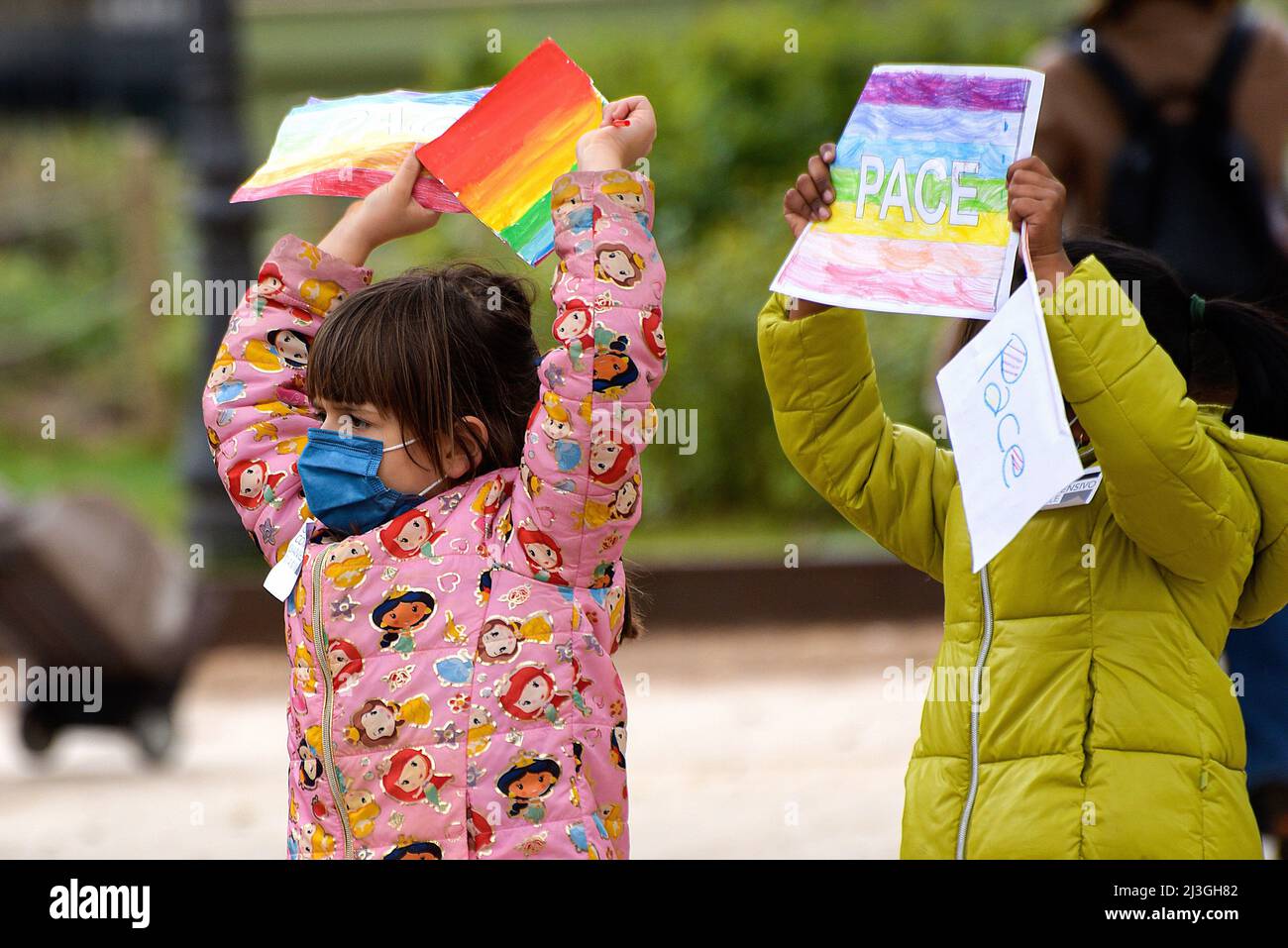 Primary school girls hold up peace flags during the demonstration. The ...