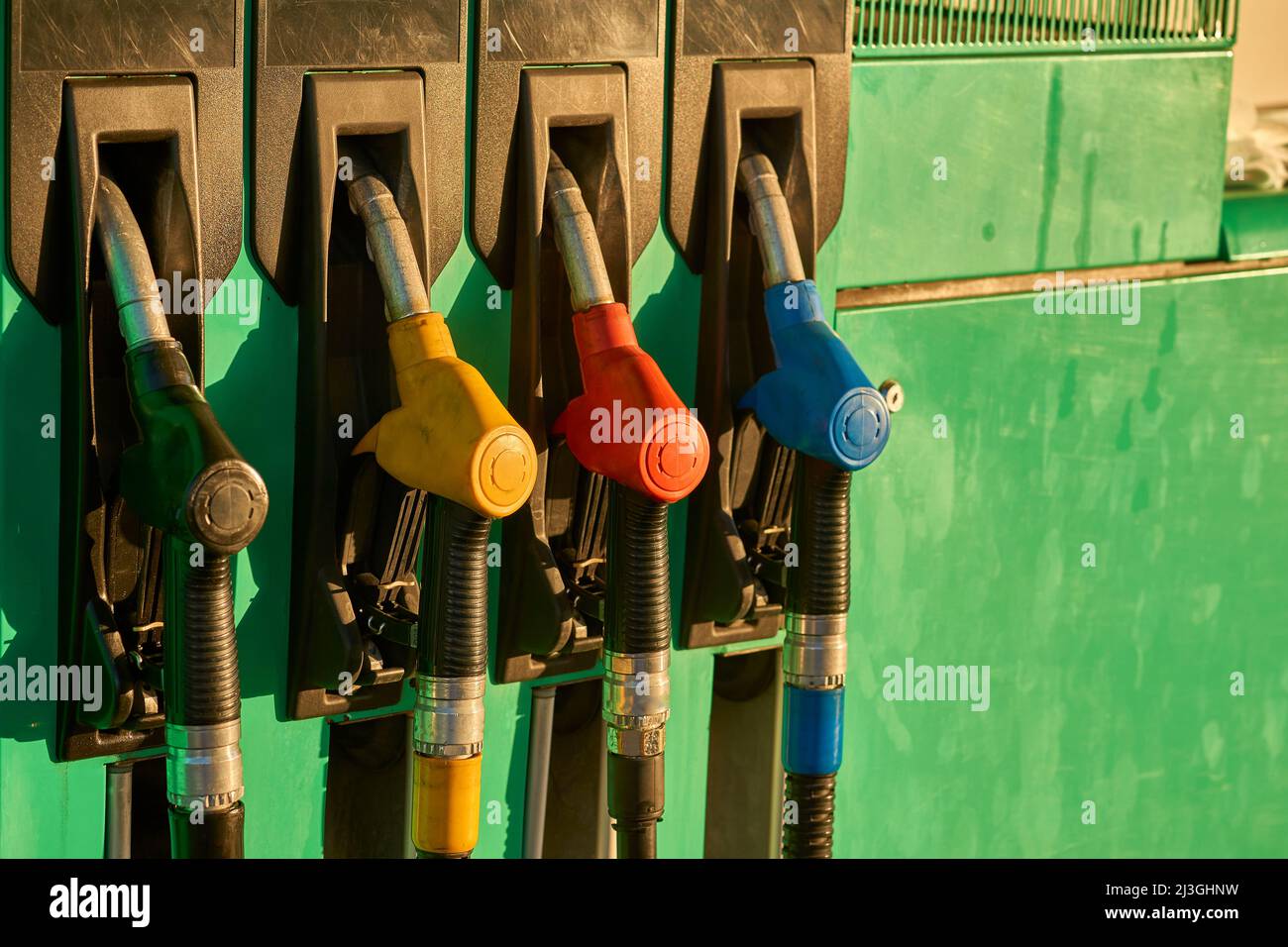 A refueling gun wakes up a gray car at a gas station Stock Photo - Alamy