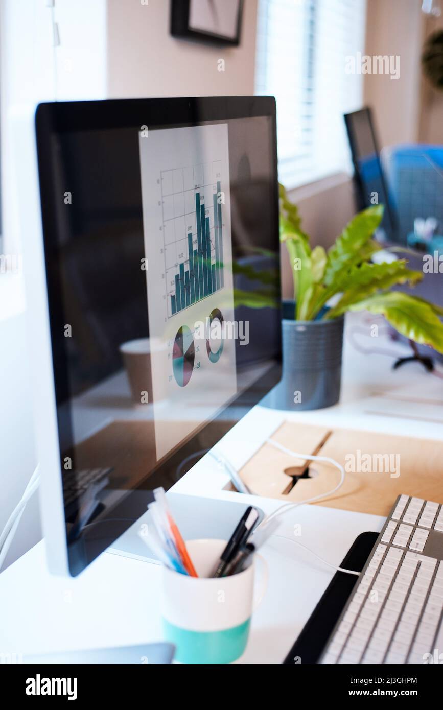 A desktop computer screen with a bar graph and pie chart in blue Stock ...