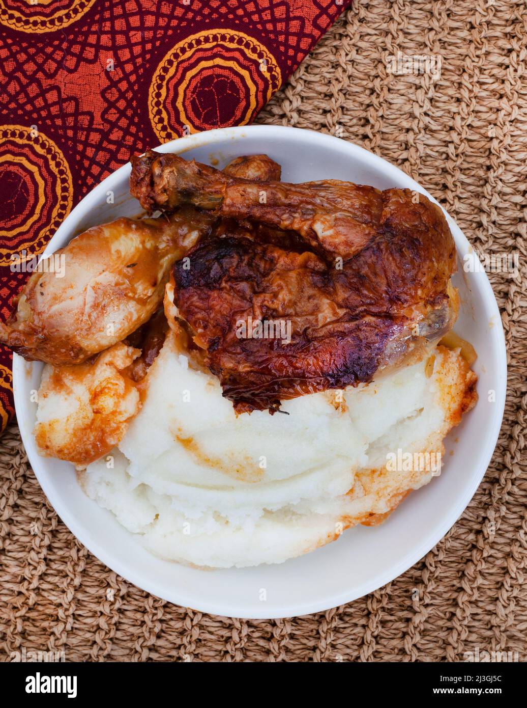 Traditional south African pap and quarter chicken, maize meal with ...