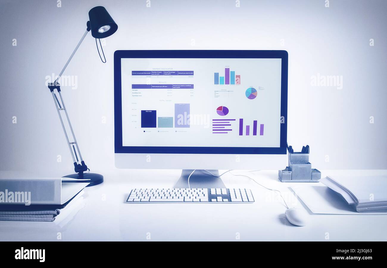 A studio shot of an office workstation. All screen content is designed ...