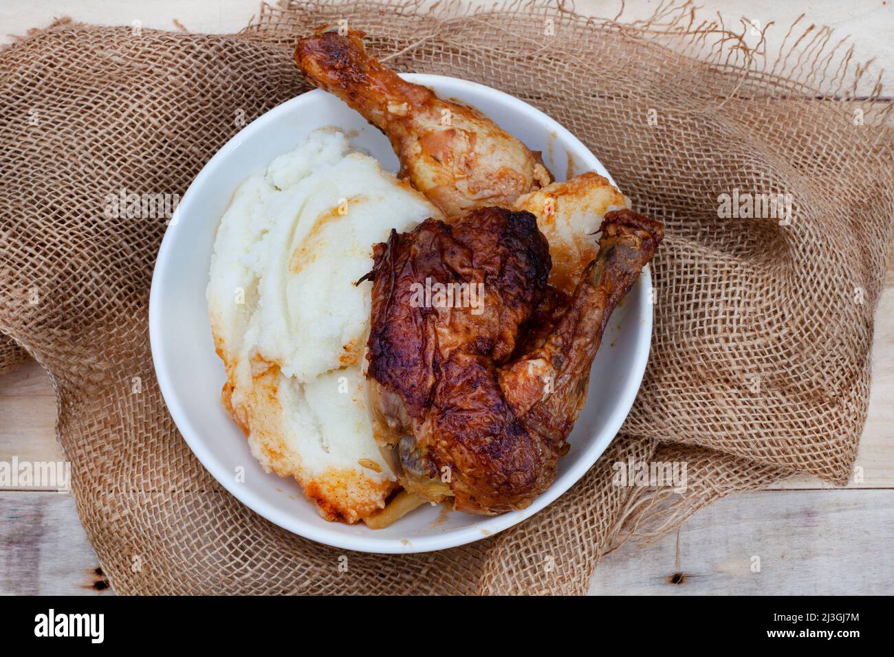 Traditional south African pap and quarter chicken, maize meal with ...