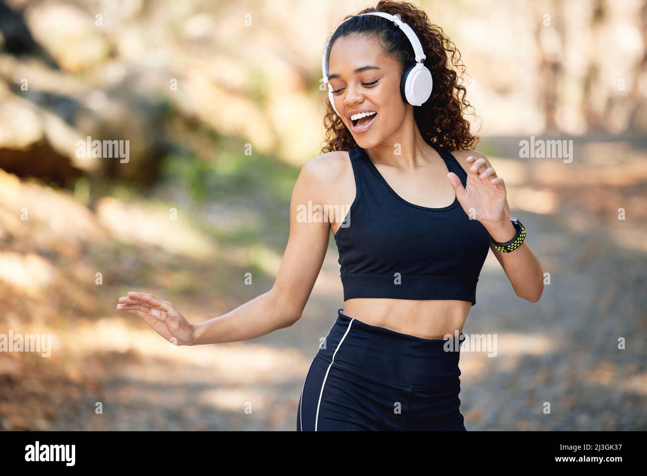 Exercise comes in many forms. Shot of a young woman dancing to fun ...
