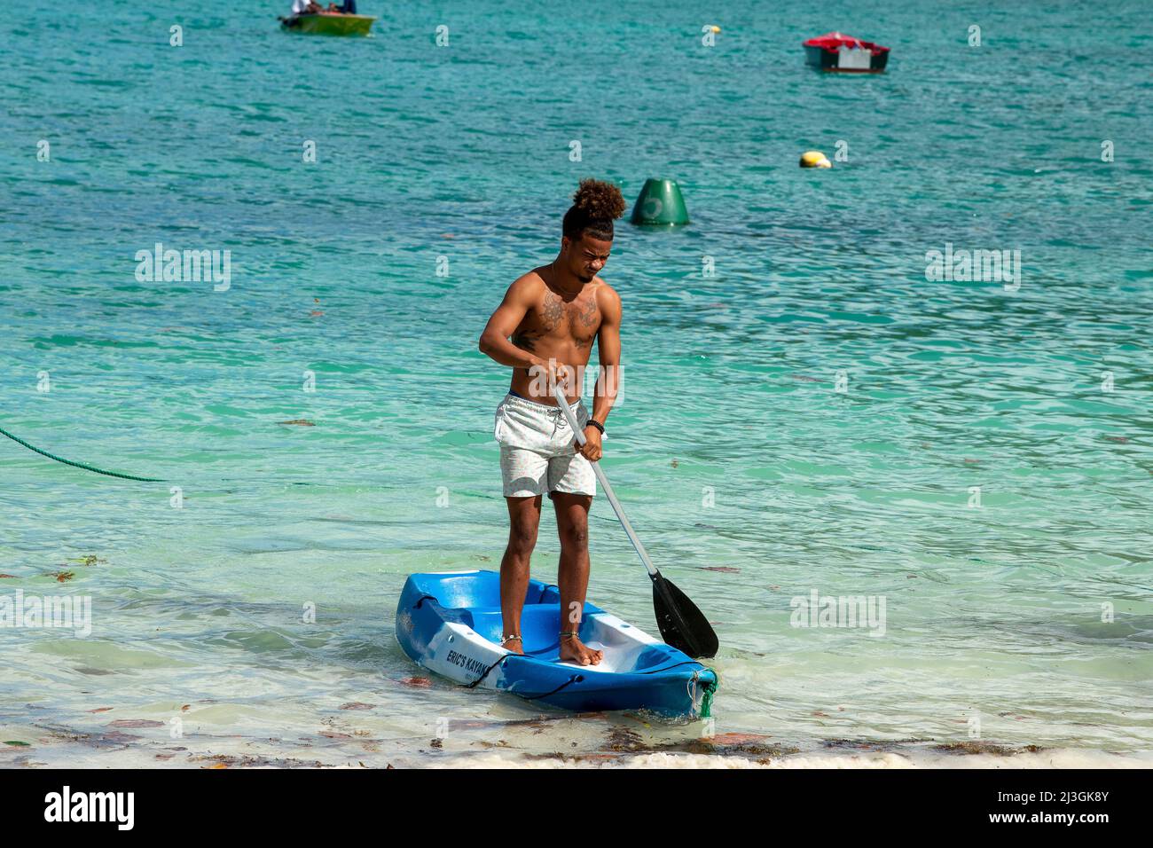 Seychellois men on Port Launay beach Mahe Seychelles Stock Photo - Alamy