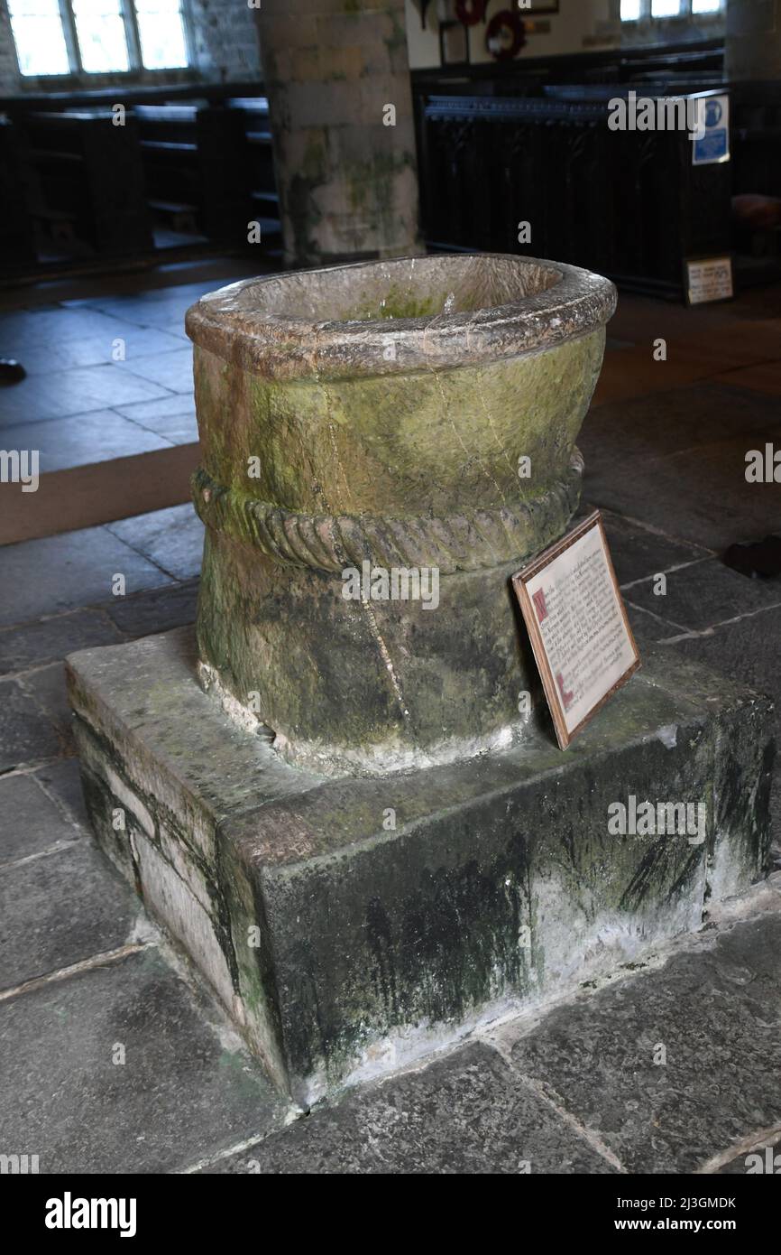 The carved stone 14th century Saxon Font in the Church of St Morwenna ...