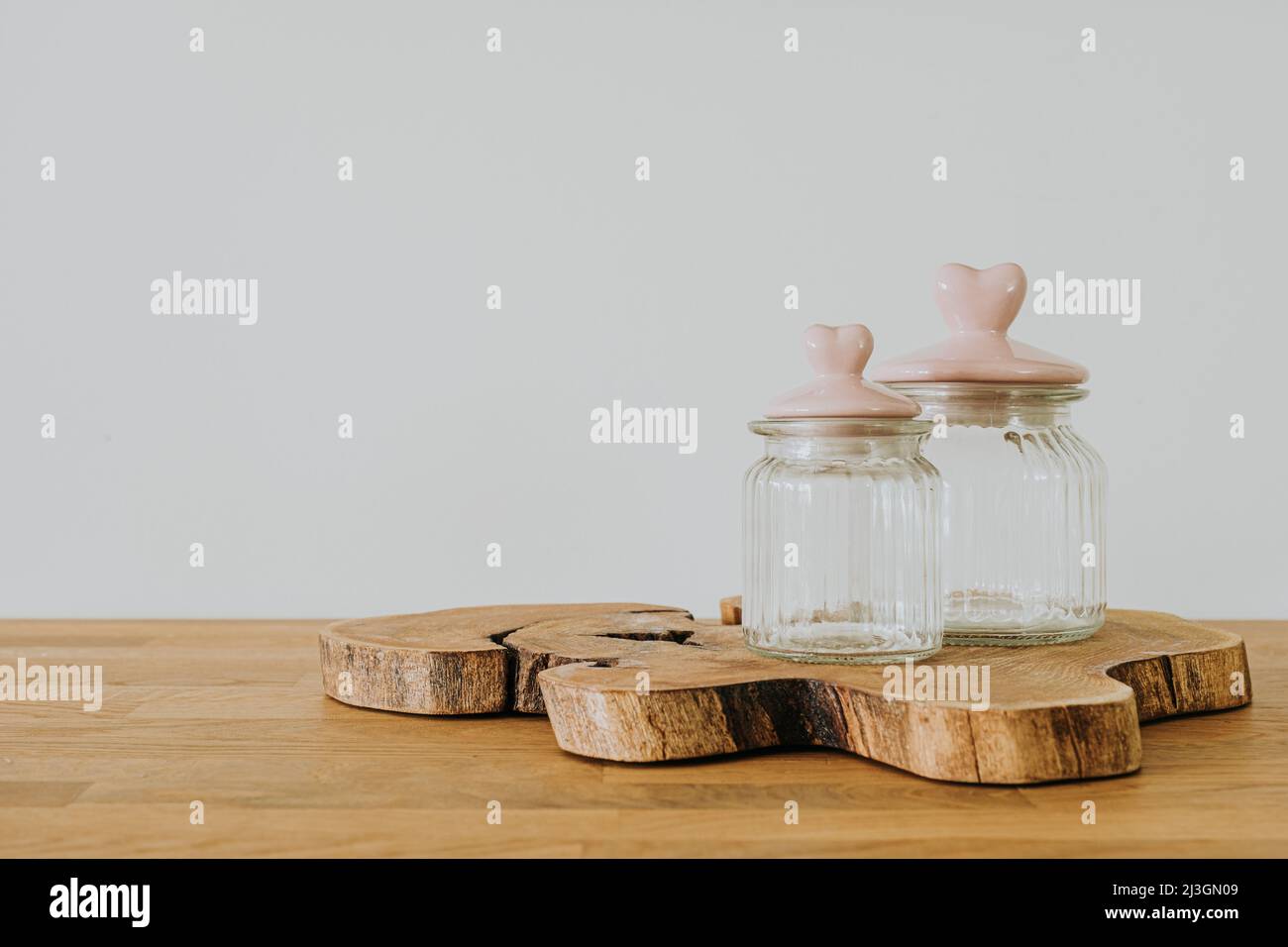 Glass jars on wooden stand and wooden desk Stock Photo - Alamy