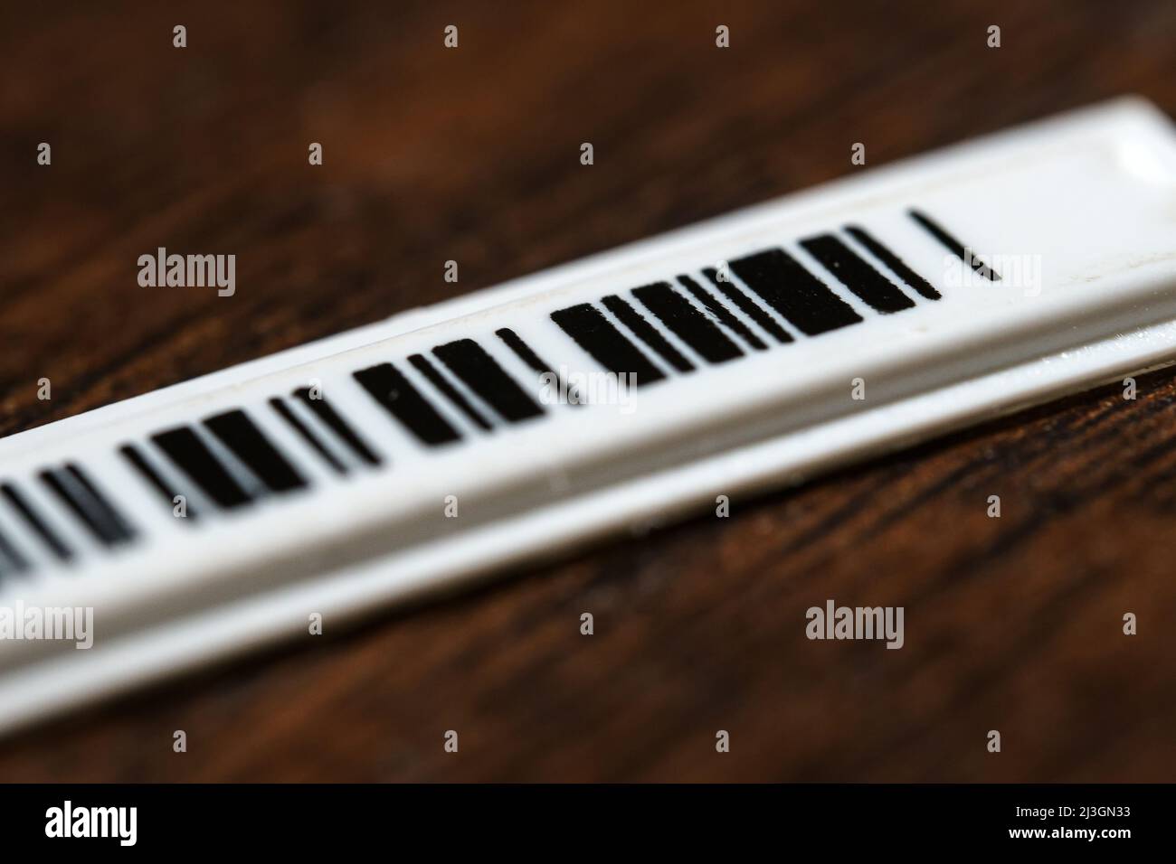 Tiny plastic security anti-theft barcode sticker with chip Stock Photo ...