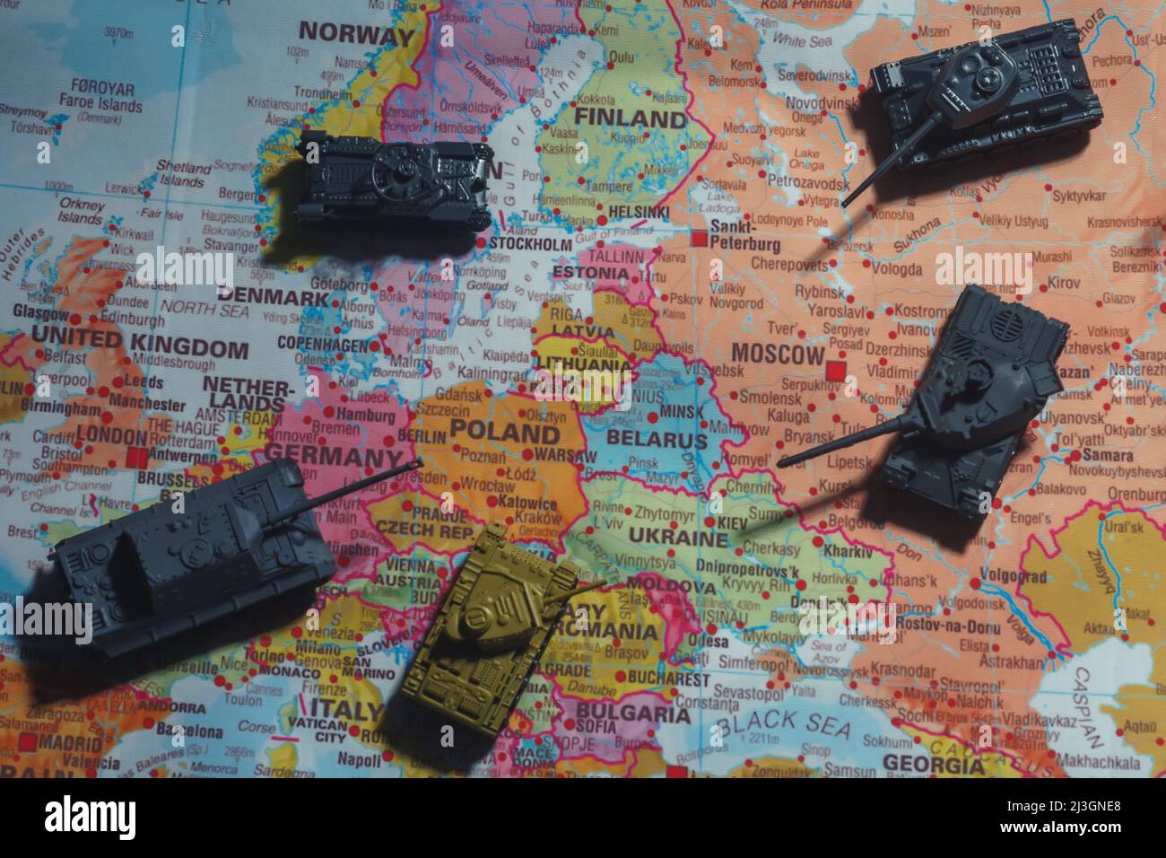Toy tanks on the map. Concept of confrontation between Europe and ...