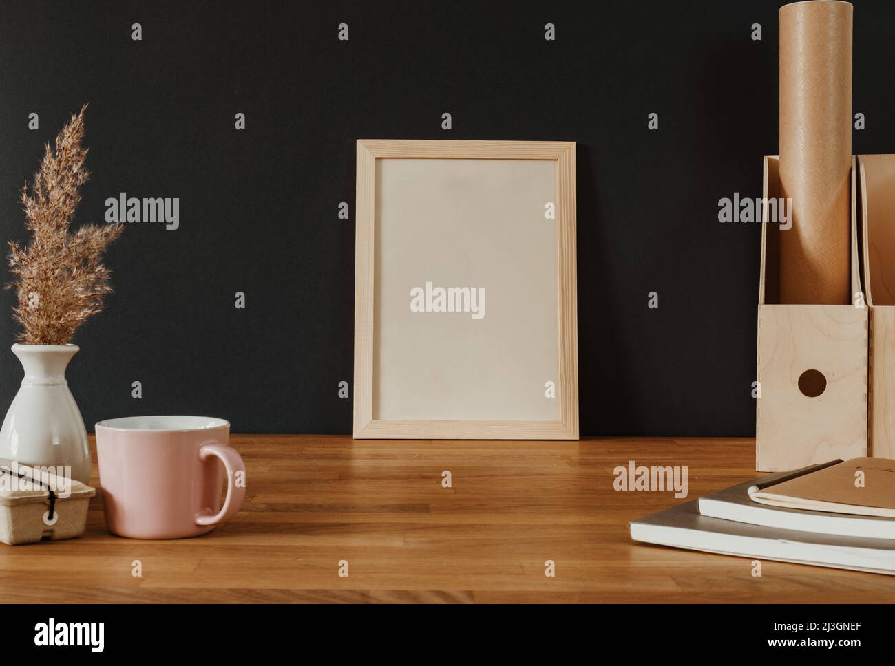 Empty white vertical frame on wooden desk Stock Photo - Alamy