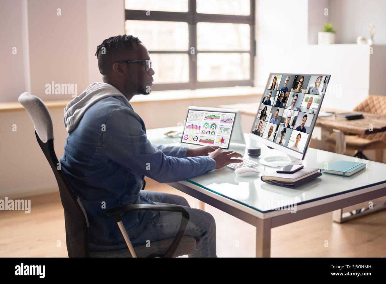 Watching Online Video Conference Meeting In Office Stock Photo - Alamy
