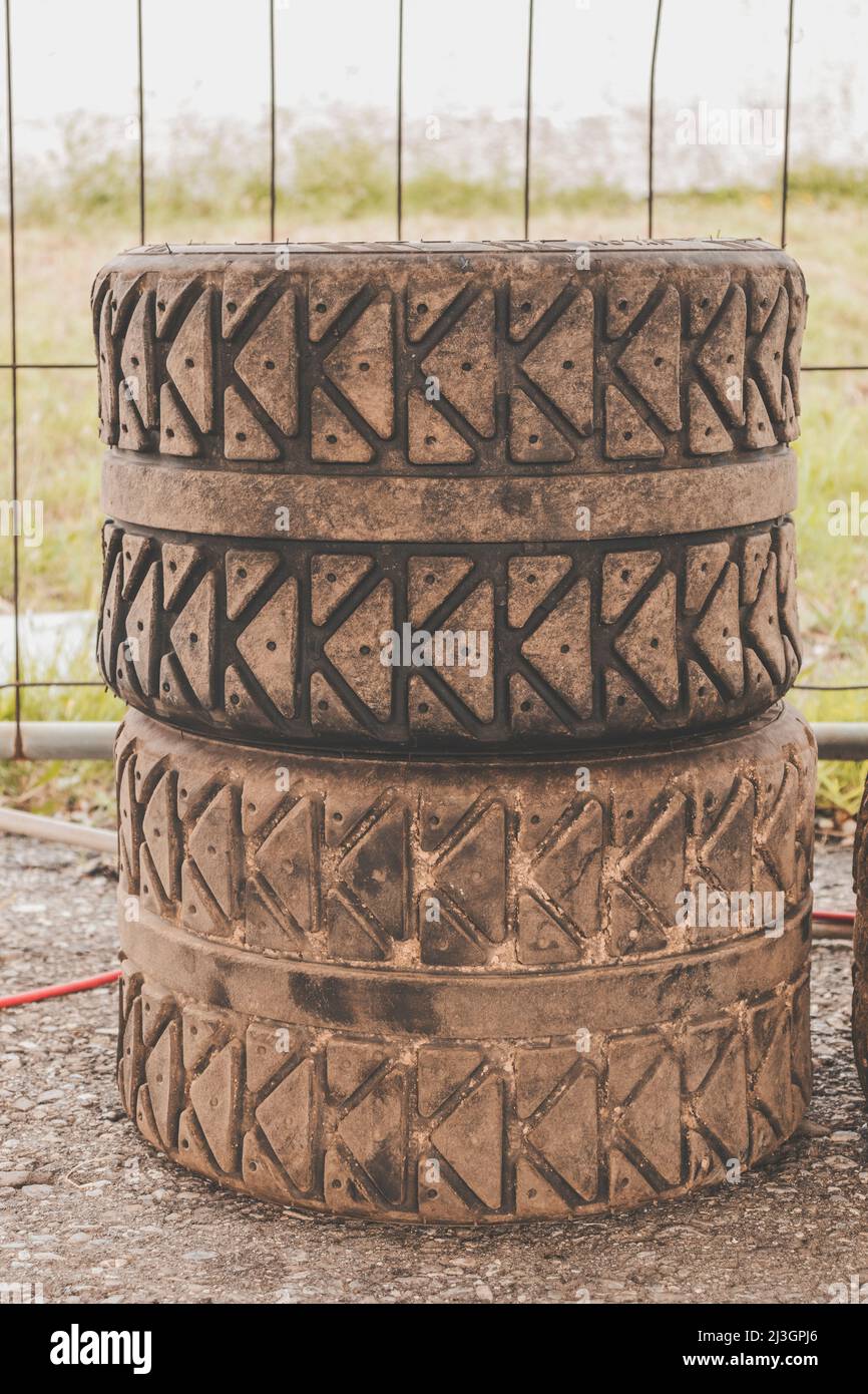 High angle view of two stacked and dirty rally tires. Vertical Stock ...
