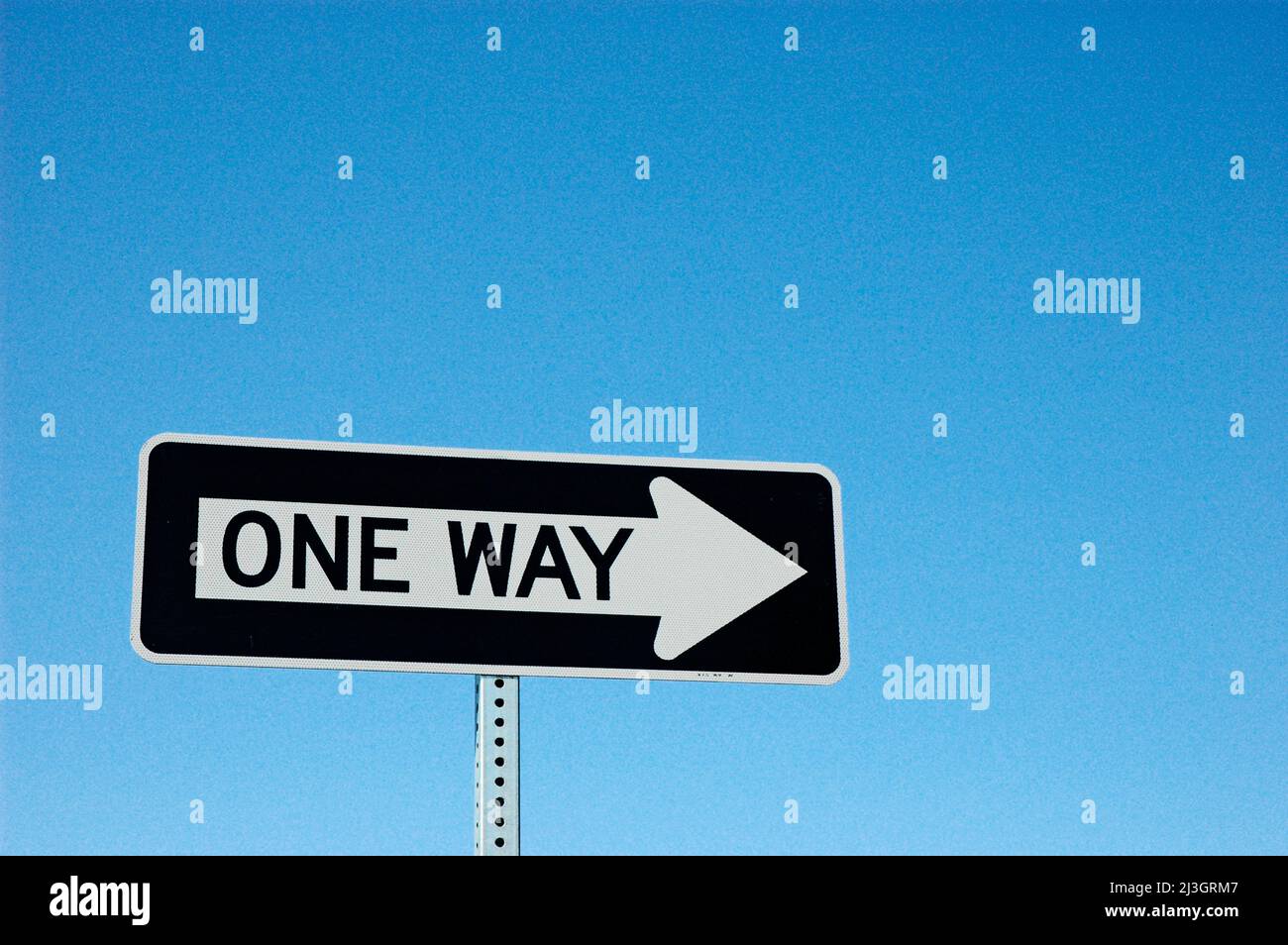 traffic sign pointing for one way travel Stock Photo - Alamy