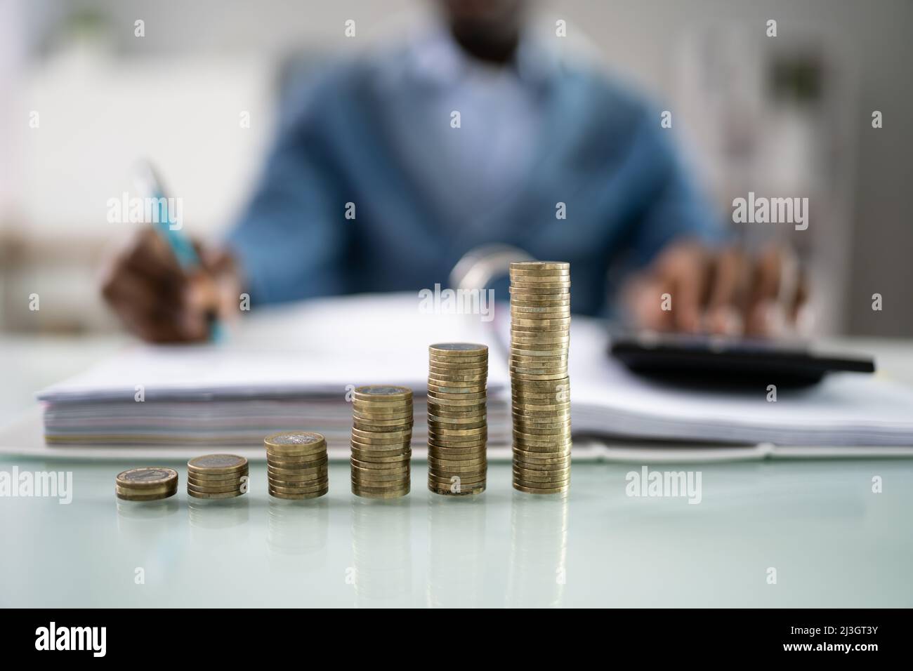 African Accountant Using Calculator. Tax Money And Coins Stock Photo ...