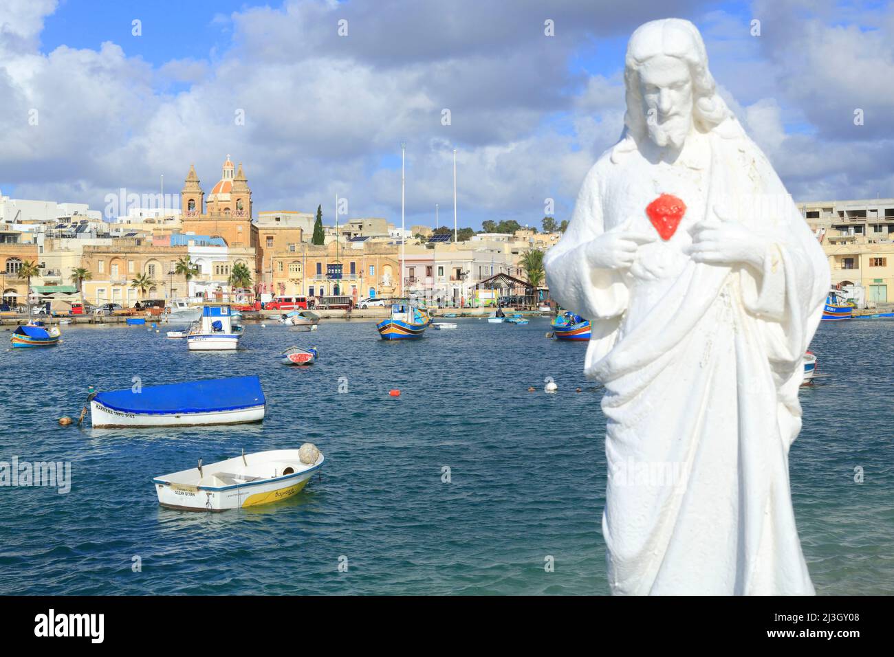 Malta, Marsaxlokk, statue of Jesus Christ with the fishing port and in ...