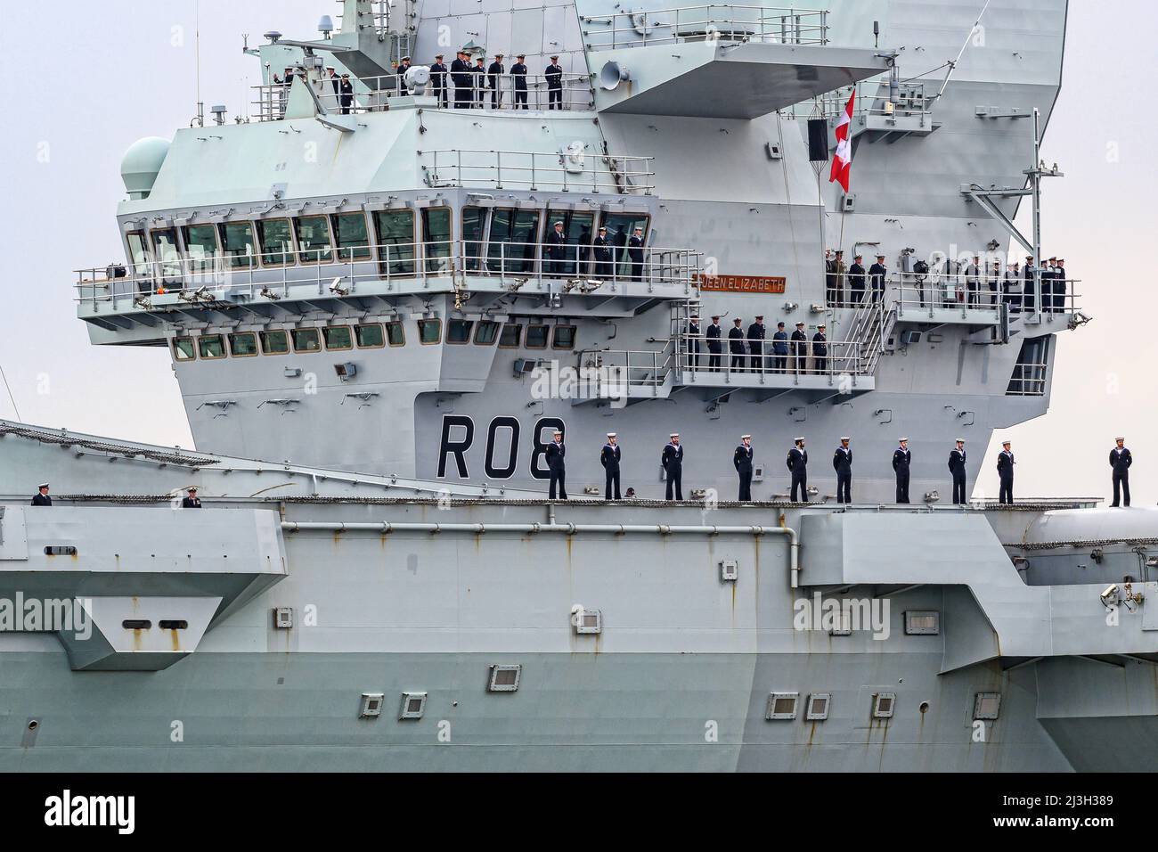 Sailors line the upper deck of the Royal Navy aircraft carrier HMS ...