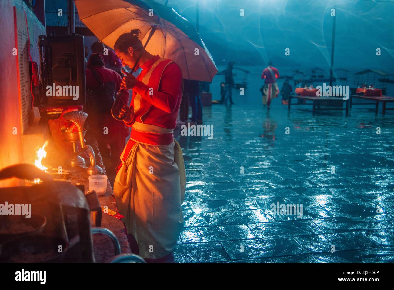 Nepalese Hindu priests perform evening Aarti ceremony during heavy rain ...