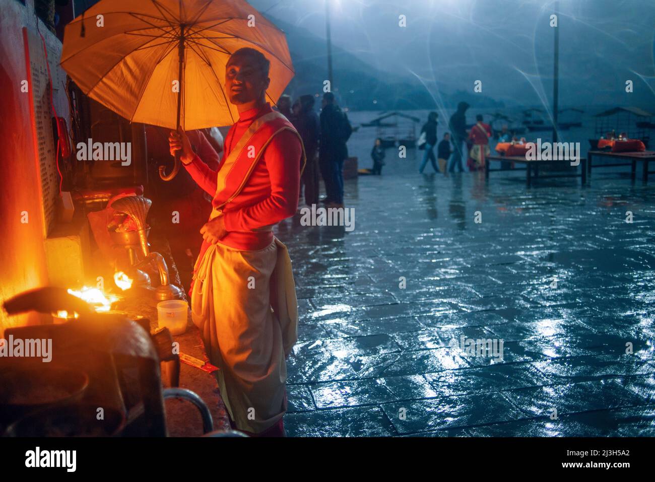 Nepalese Hindu priests perform evening Aarti ceremony during heavy rain ...