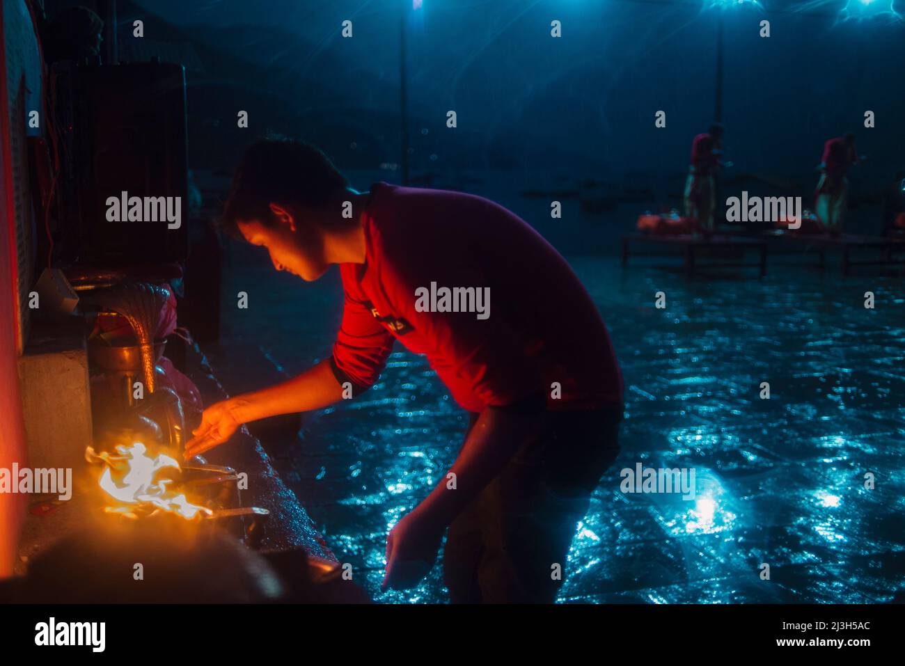 Nepalese Hindu priests perform evening Aarti ceremony during heavy rain ...
