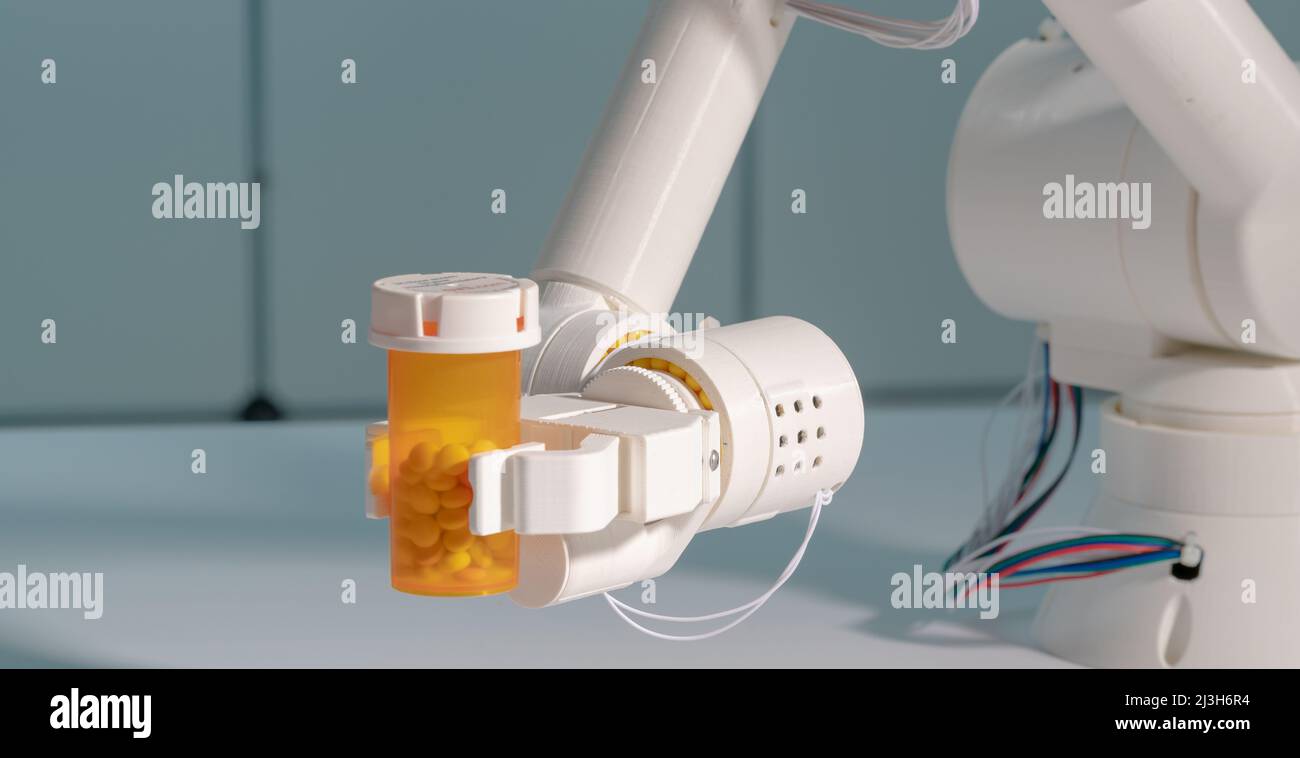 Robot arm with a pills in bottle in the laboratory. The concept of ...