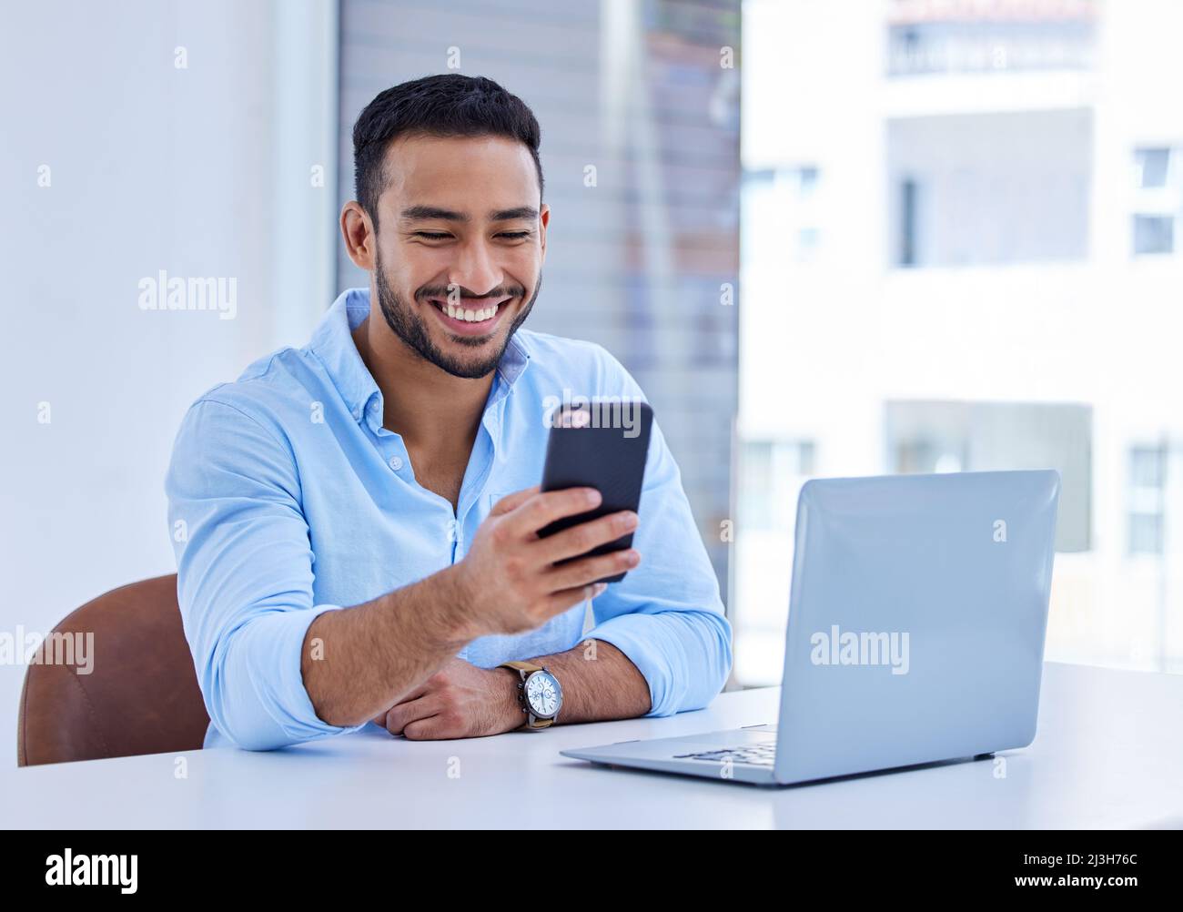 Romantic texts always make my day. Shot of a businessman using his ...