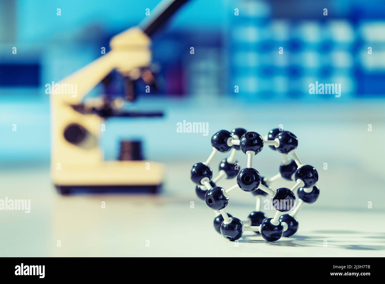 Microscope and model of chemical molecule in school class Stock Photo ...