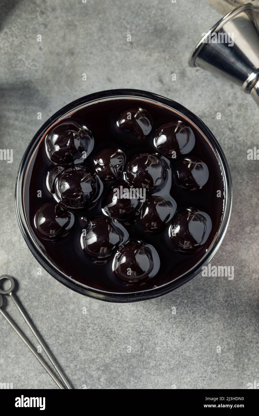 Organic Boozy Dark Maraschino Cherries as a Garnish for Cocktails Stock ...