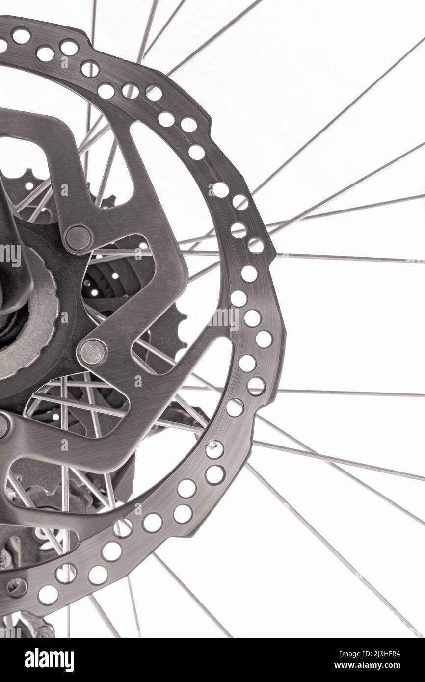 Close up of bicycle with brake disc and spokes in black and white on ...