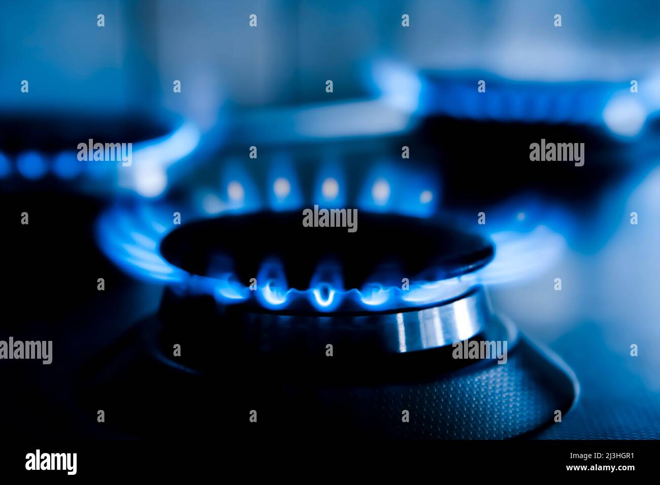 Blue gas flames against dark background Stock Photo - Alamy