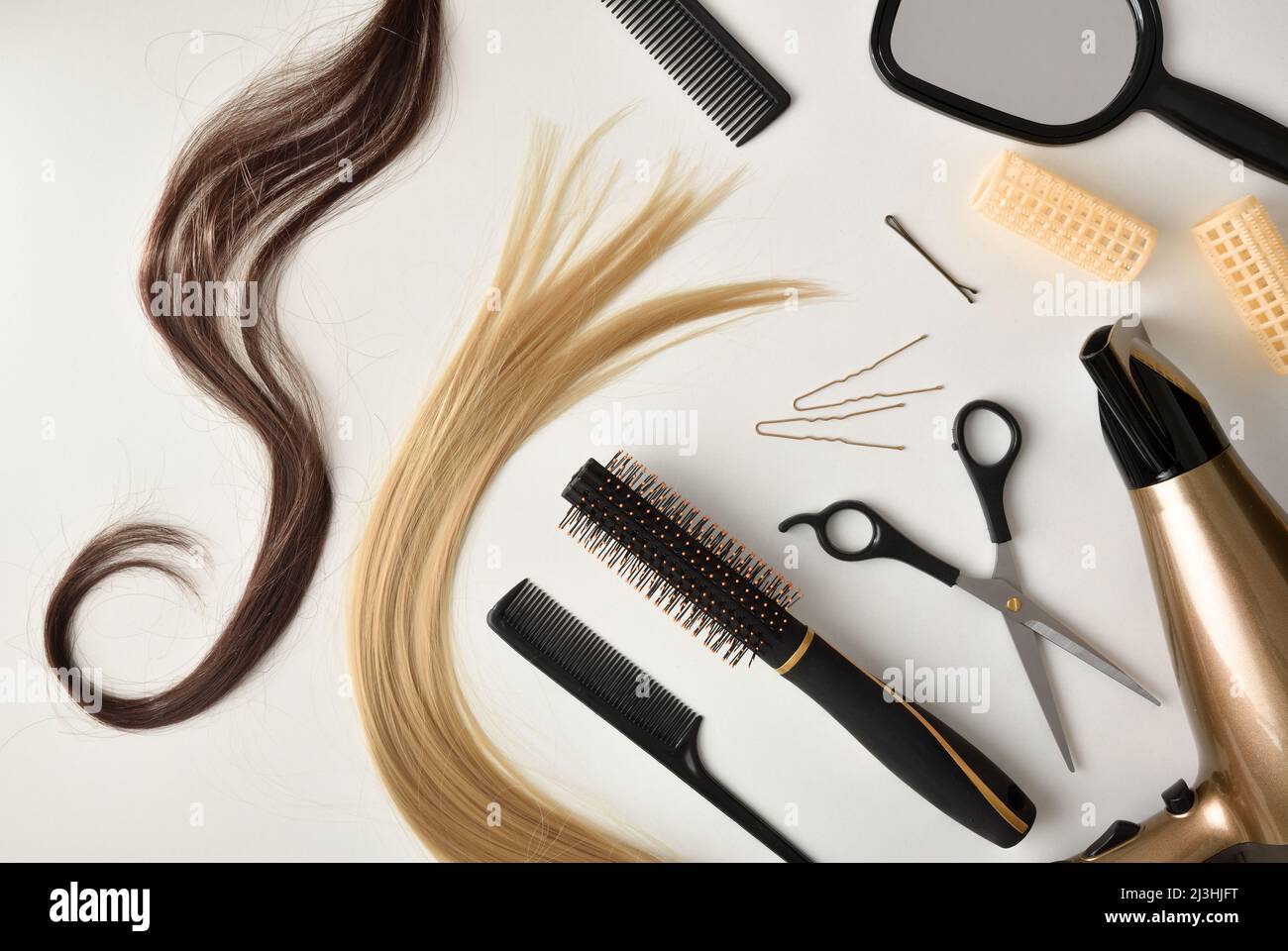 Set of tools for hair cutting and styling on white table. Top view ...