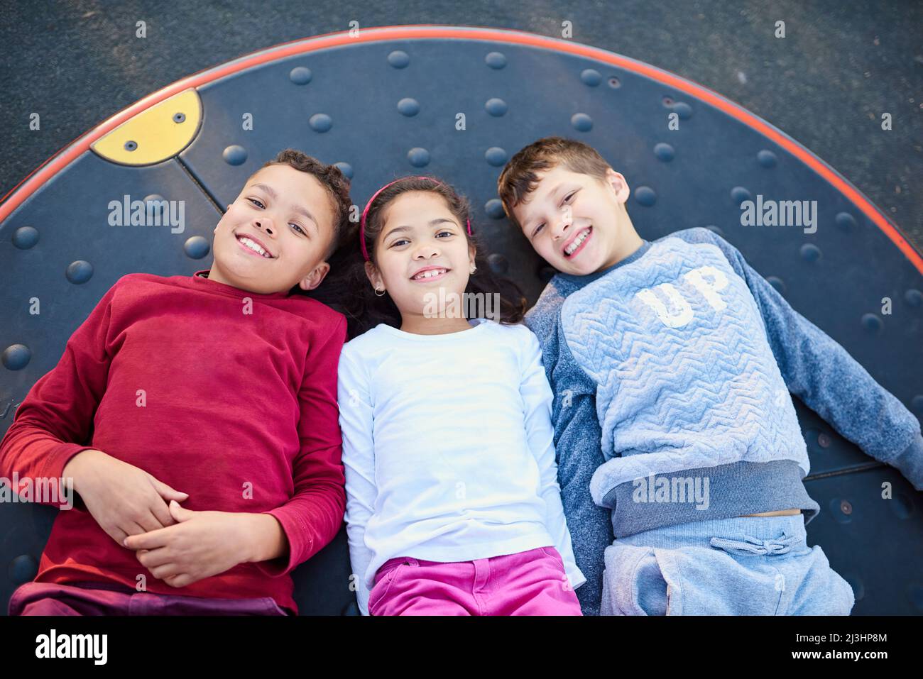 Fun times at our favourite place. Portrait of three young siblings ...