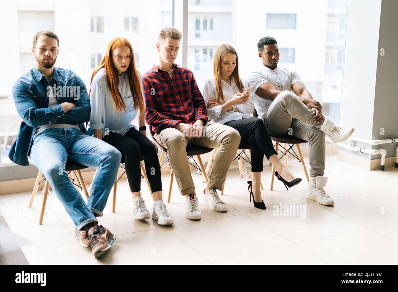 Tired young diverse multiethnic job candidates in casual clothes ... Tired young diverse multiethnic job candidates in casual clothes ...