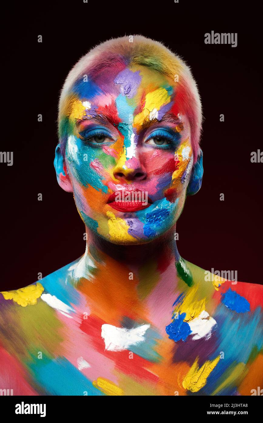 Adding colour makes all the difference. Studio shot of a young woman ...