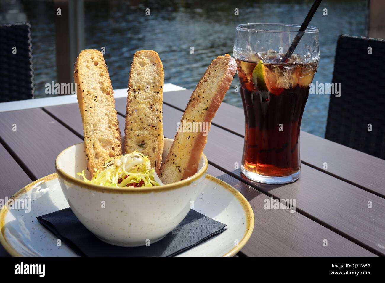 Bread and dip, restaurant food / starter and a fizzy drink of a table ...