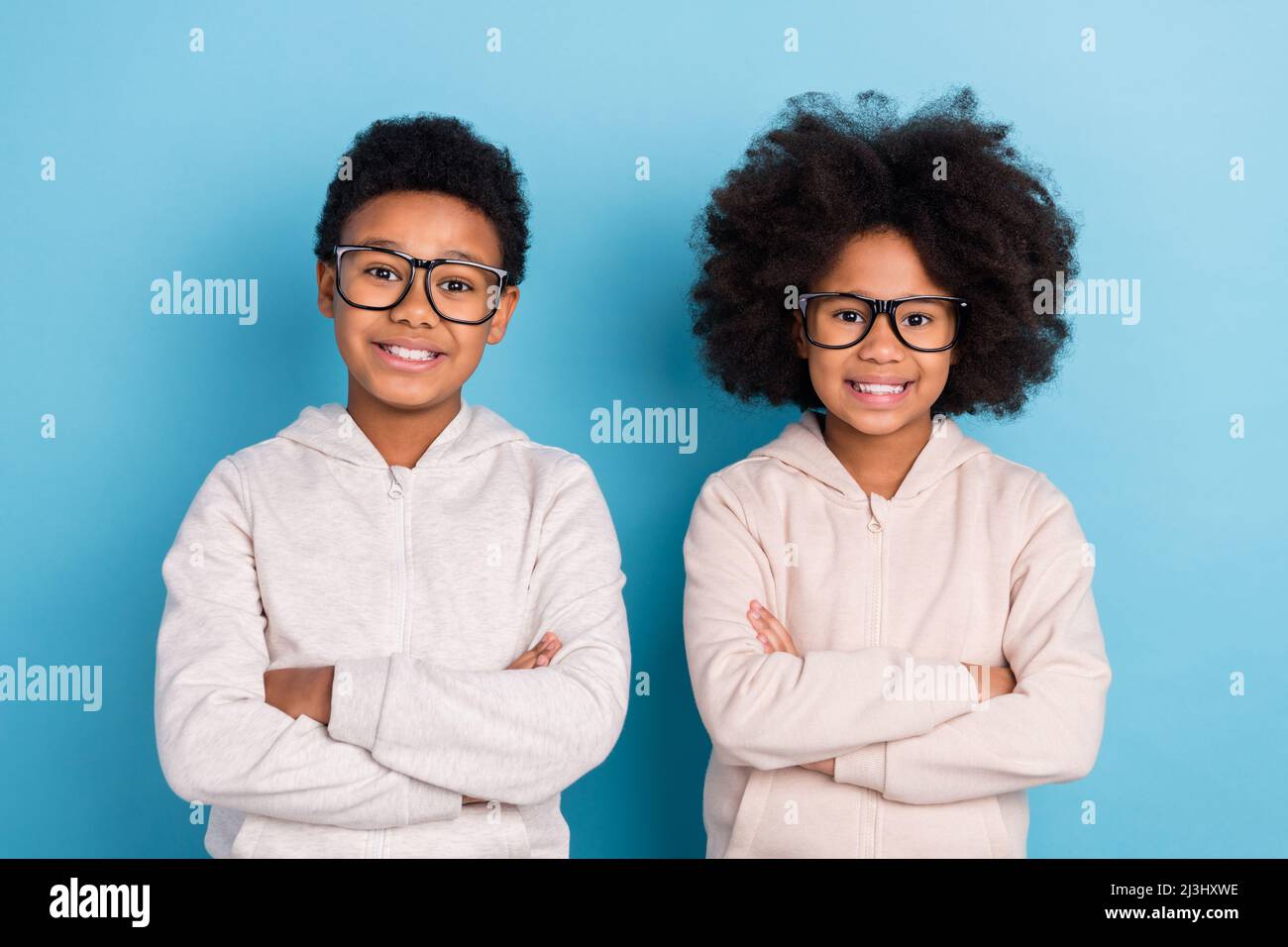 Portrait of attractive cheerful brunet kids nerds schoolkids folded ...