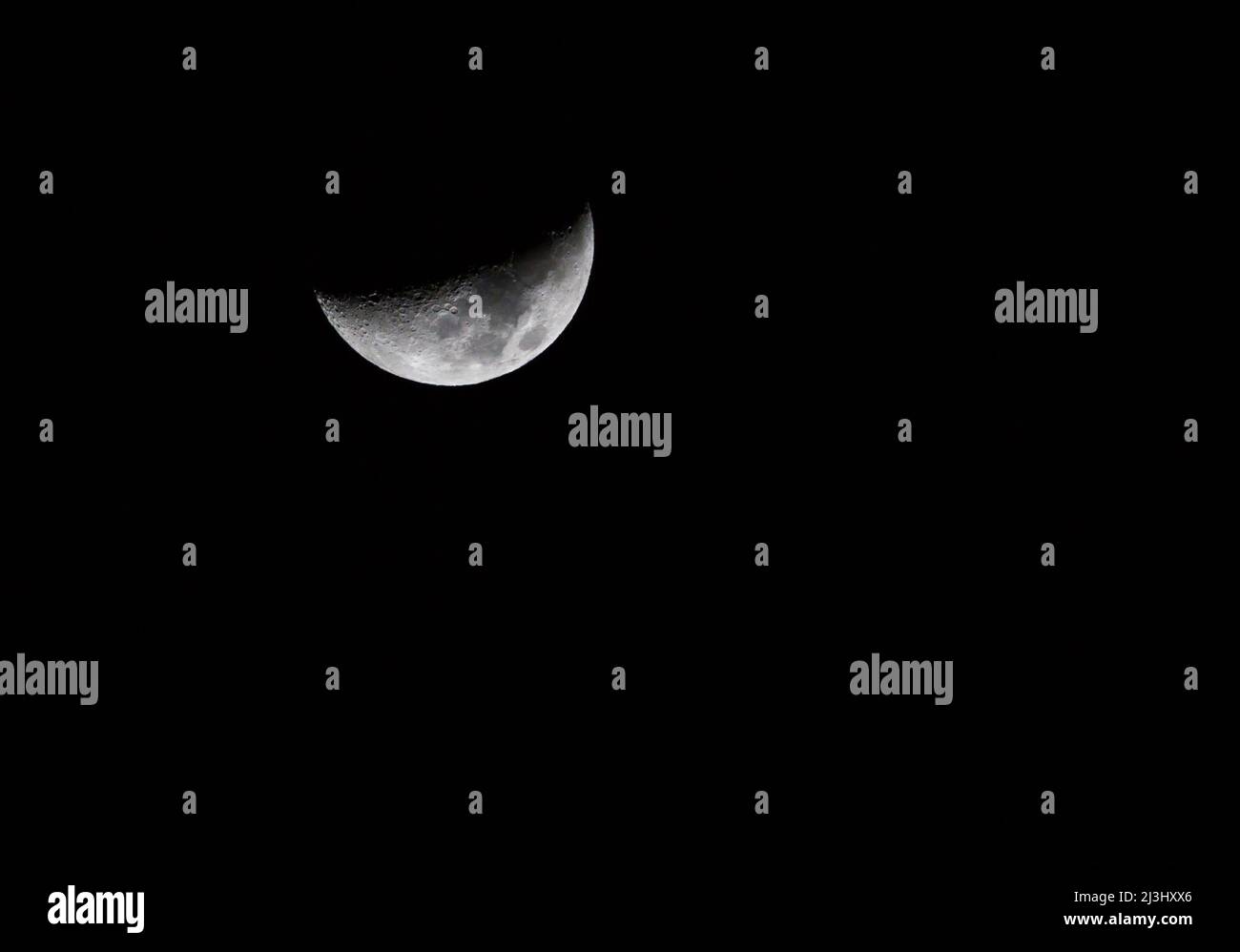 A horizontal composition of a crescent moon with copy space in a deep ...