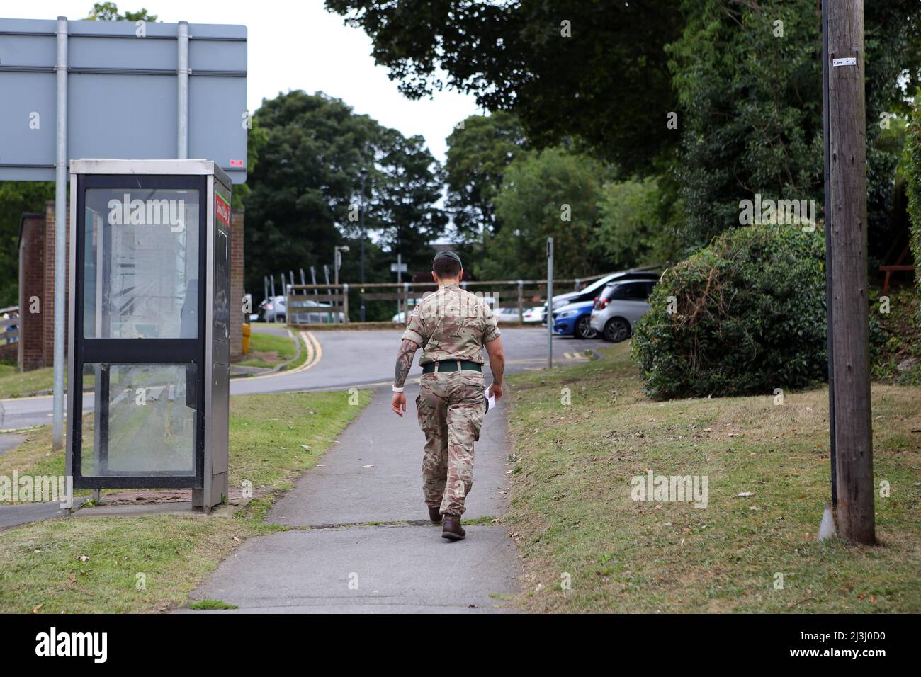 A Soldier walks along a street in the town of Catterick Garrison in ...