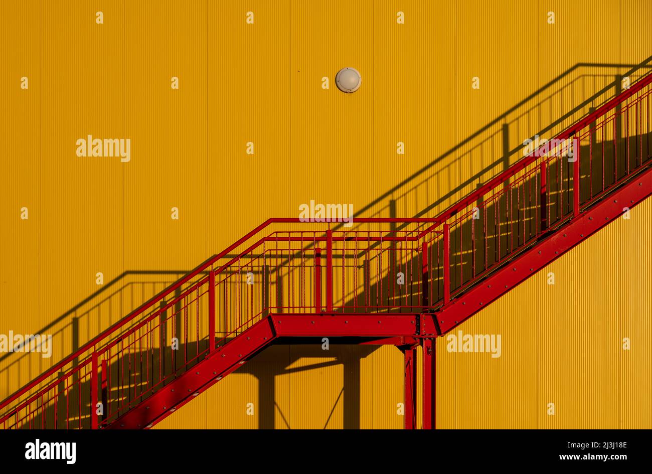 yellow warehouse, red stairs, shadow Stock Photo - Alamy