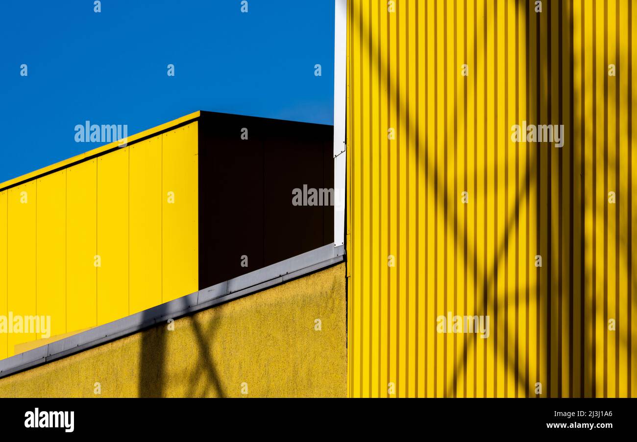 yellow warehouse, blue sky, shadow Stock Photo - Alamy