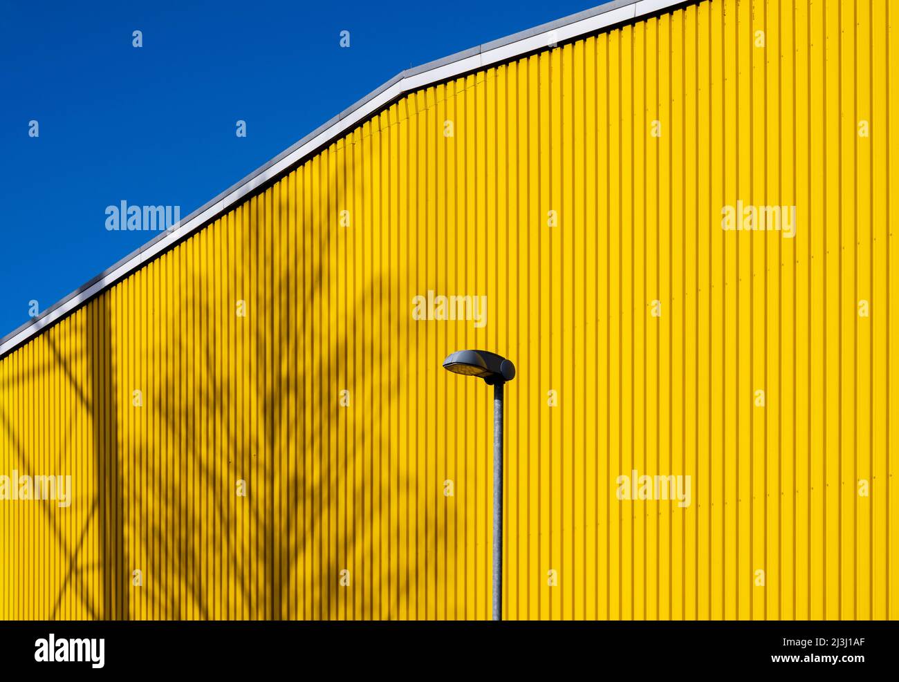 yellow warehouse, blue sky, lantern, shadow Stock Photo - Alamy