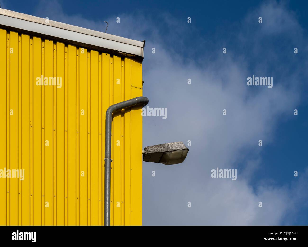 yellow warehouse, blue sky, lamp Stock Photo - Alamy