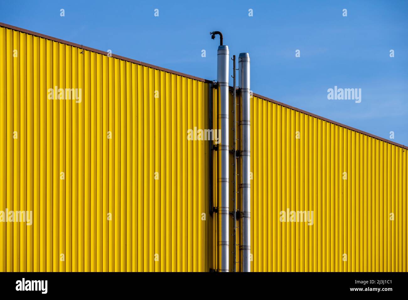 yellow warehouse, blue sky, chimney Stock Photo - Alamy