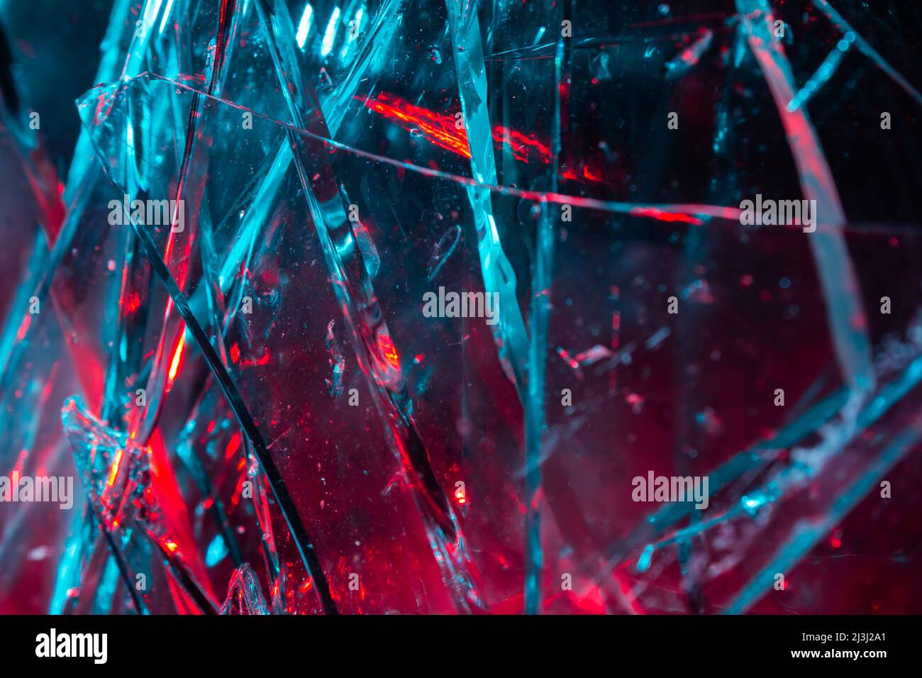 Close-up photo texture of blue and red toned broken and cracked glass ...