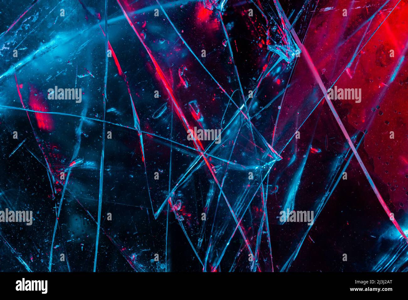 Close-up photo texture of blue and red toned broken and cracked glass ...