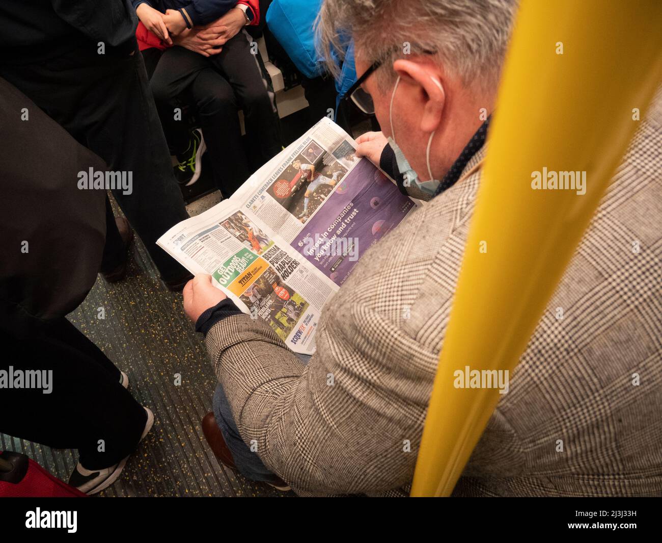 Man reading Metro newspaper on London Underground tube train Stock ...