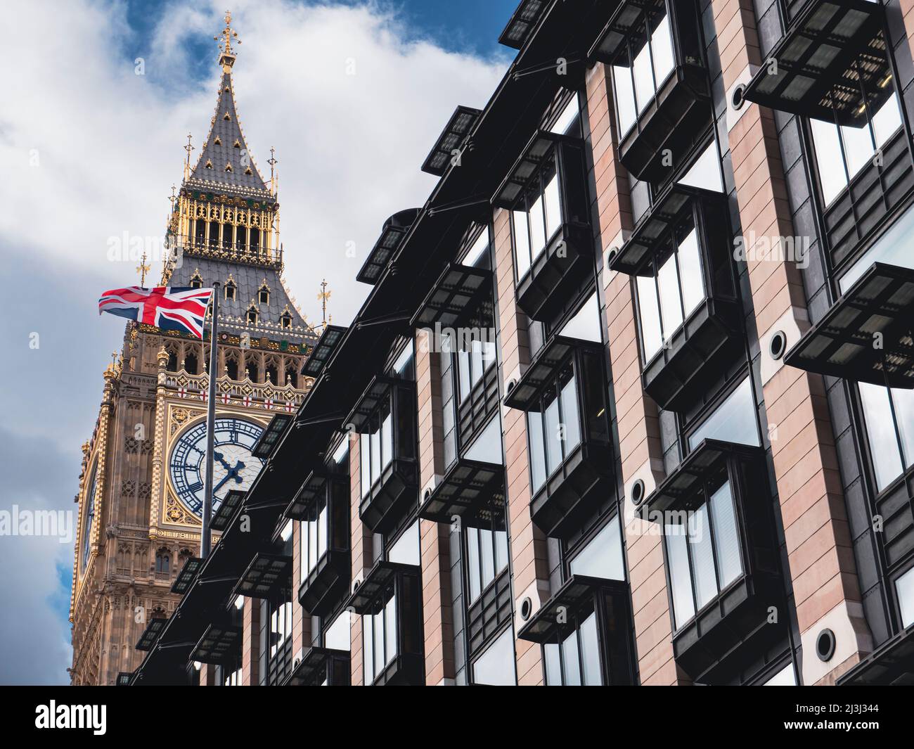 Portcullis House and Big Ben with Union flag, Union Jack in Westminster ...
