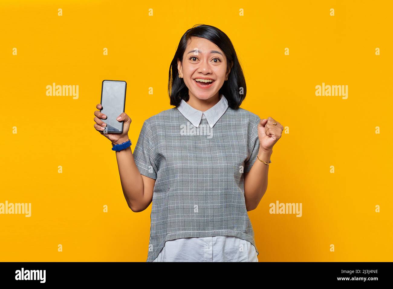 Happy asian woman showing mobile phone blank screen and hand gesture ...