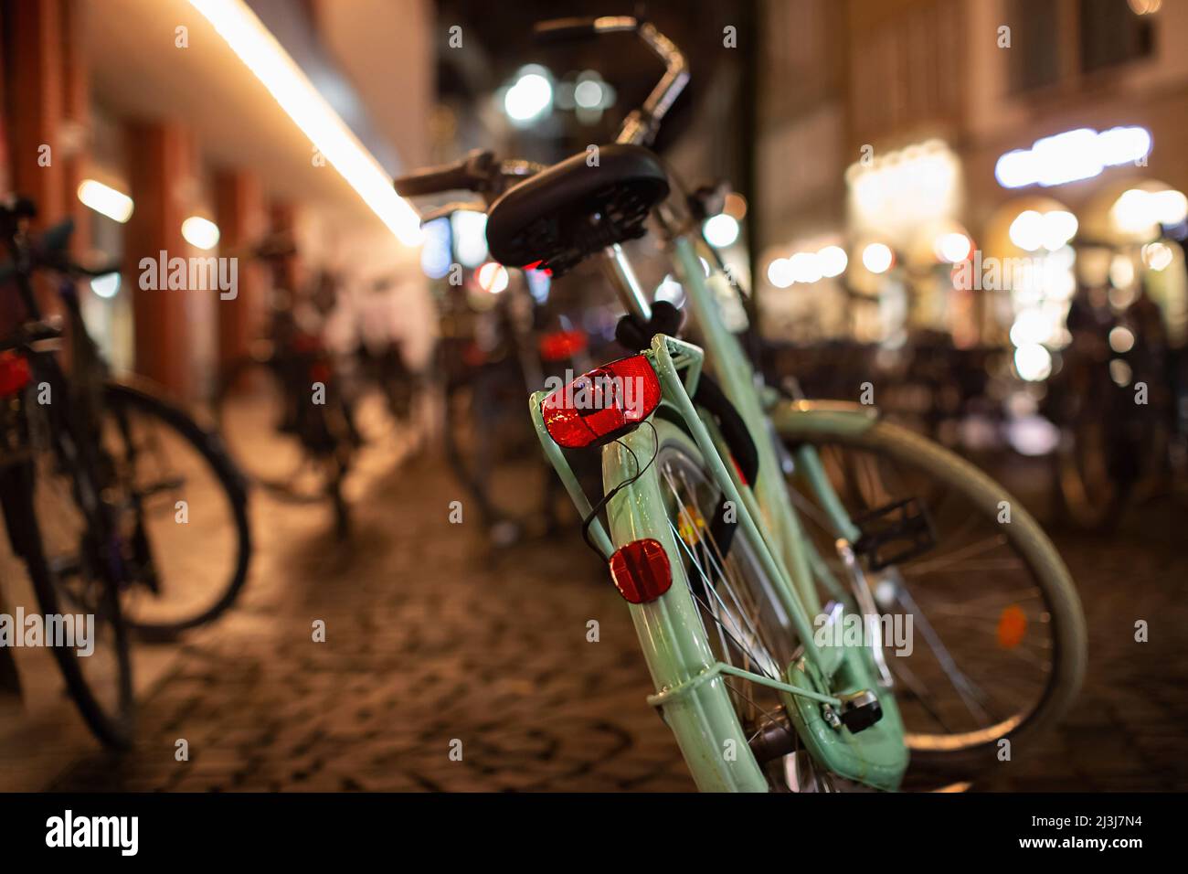 Bicycles parked on a sidewalk Stock Photo - Alamy