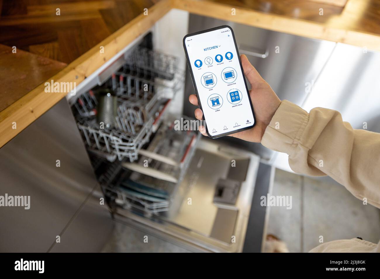 Controlling dishwasher with smart phone application Stock Photo - Alamy